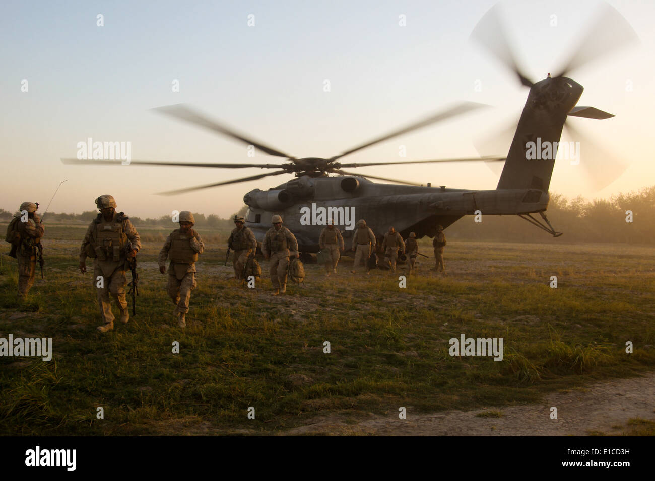 U.S. Marines from 1st Battalion, 5th Marine Regiment disembark a CH-53E ...