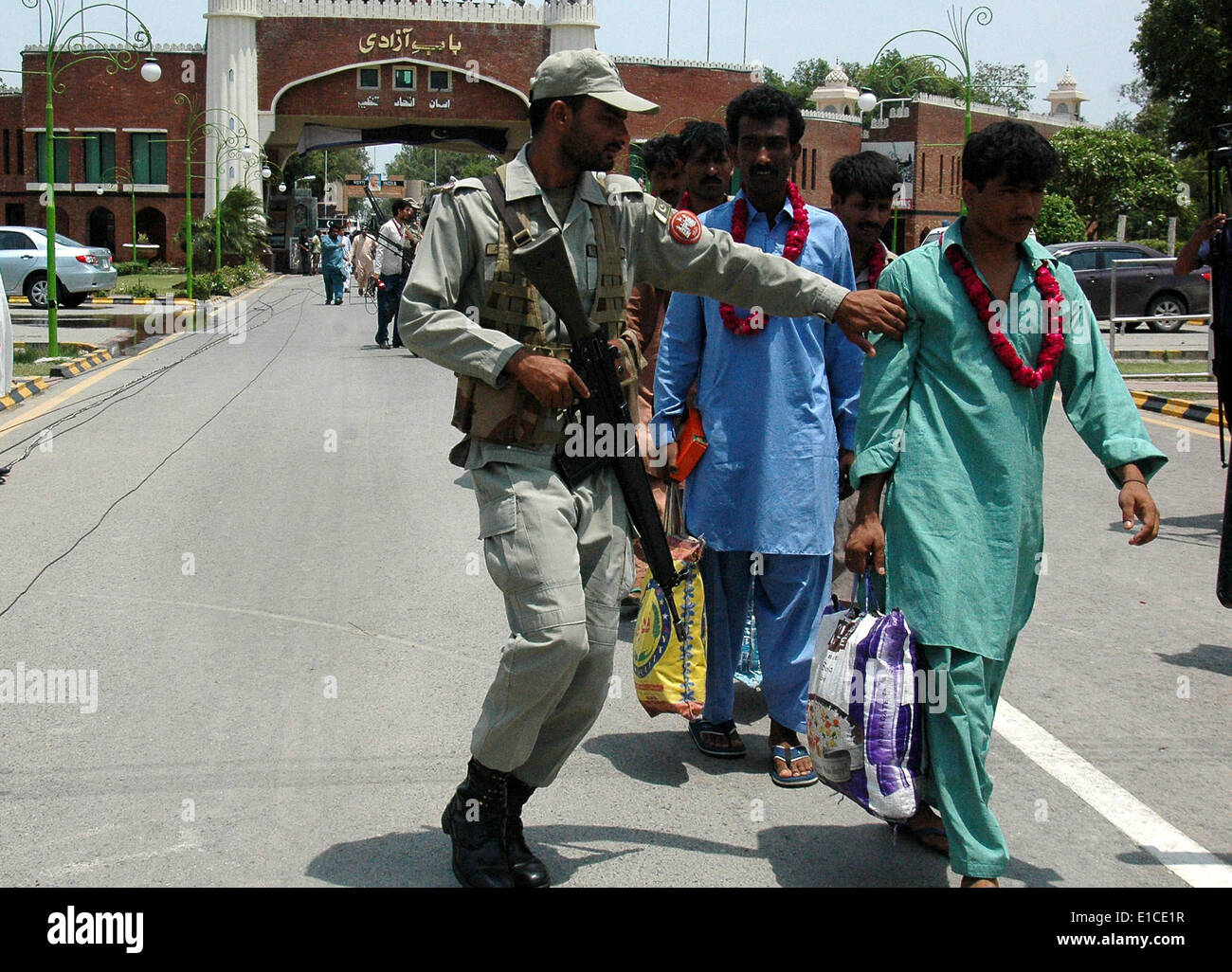 Lahore. 30th May, 2014. Released Pakistani prisoners walk across the ...