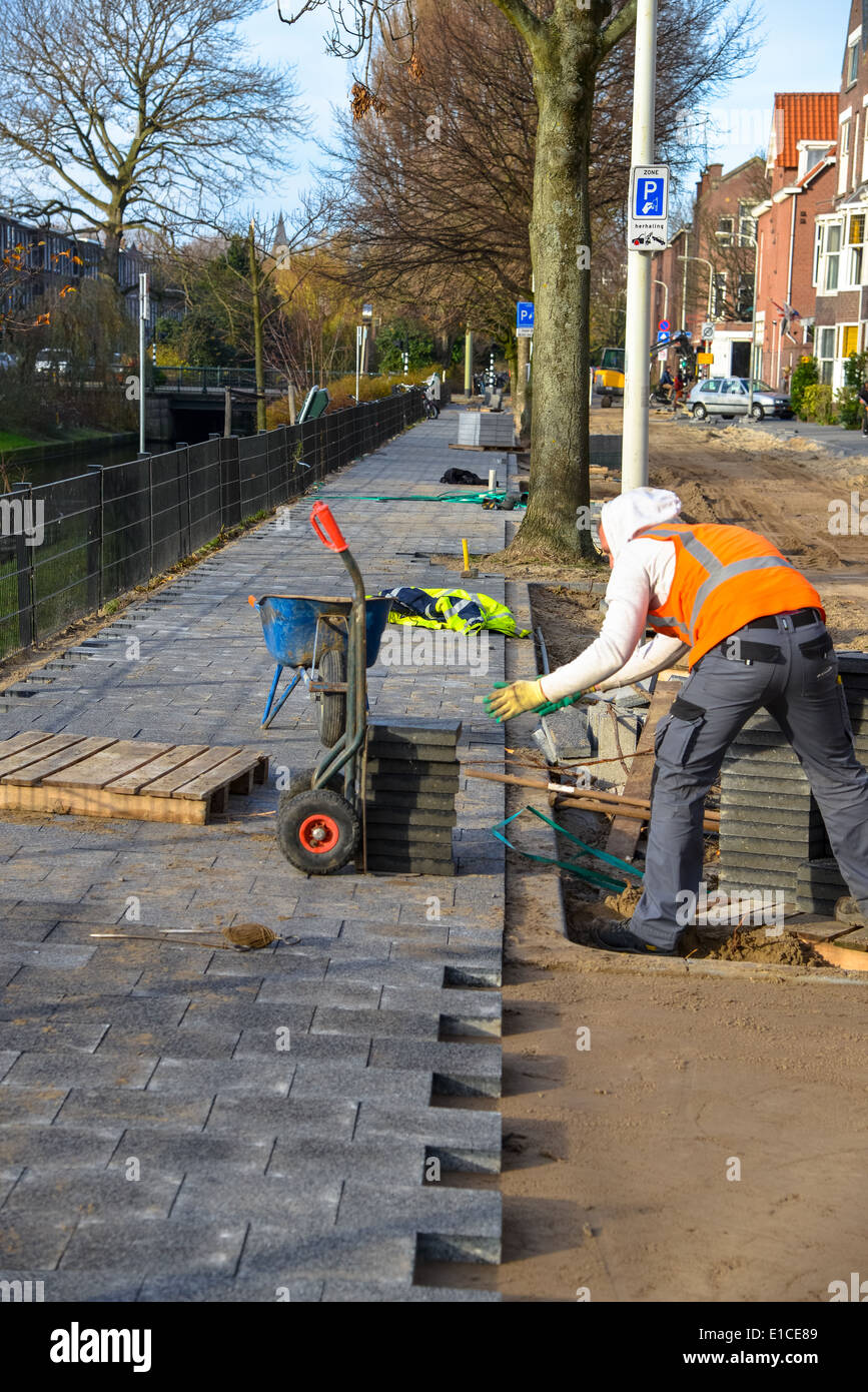 paviours at work in street in town Stock Photo - Alamy