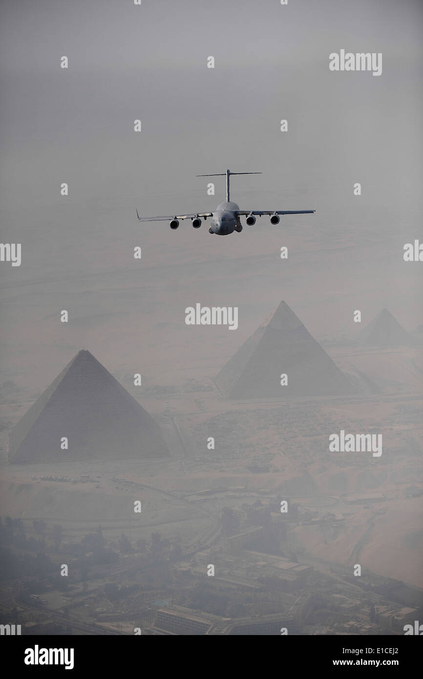 A U.S. Air Force C-17 Globemaster III aircraft flies over the pyramids ...