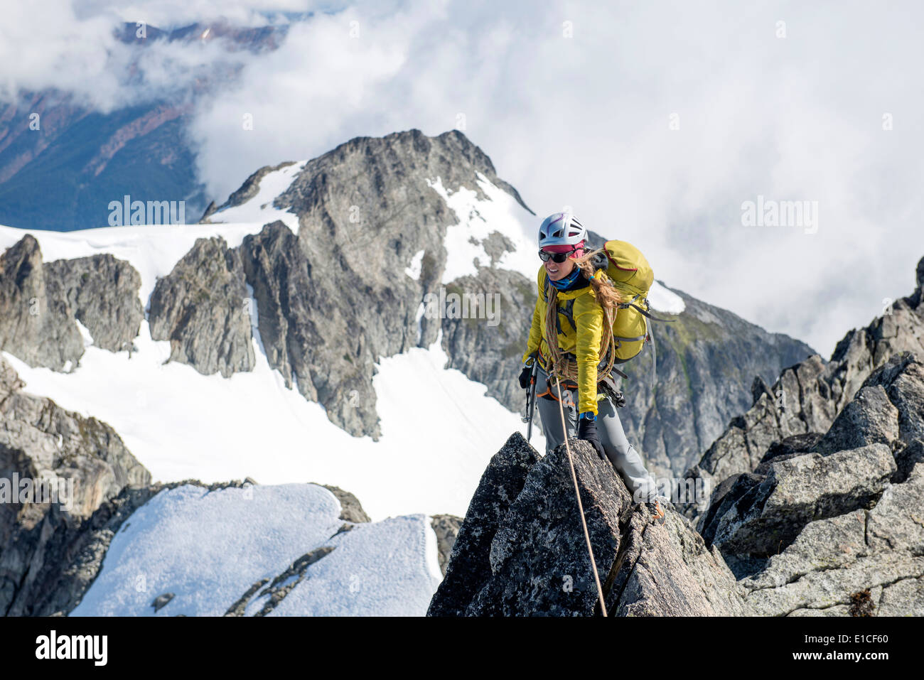 Woman climbing on the North Ridge of Forbidden Peak in North Cascades ...