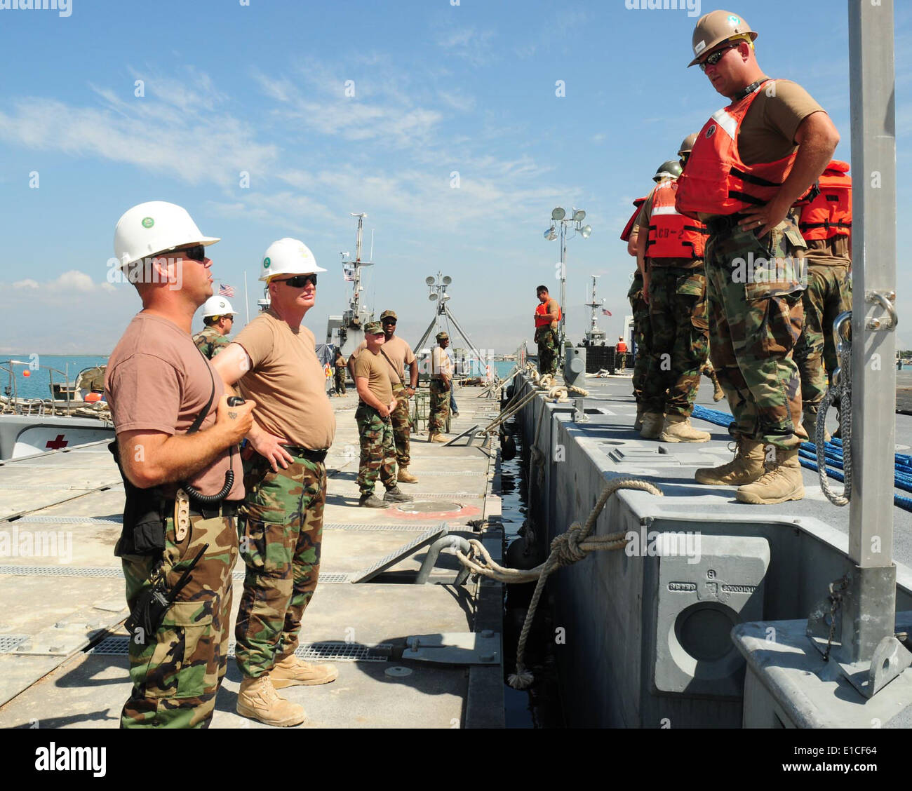 100213 PORT AU PRINCE -- Sailors from Naval Beach Group (NBG) 2 get ...