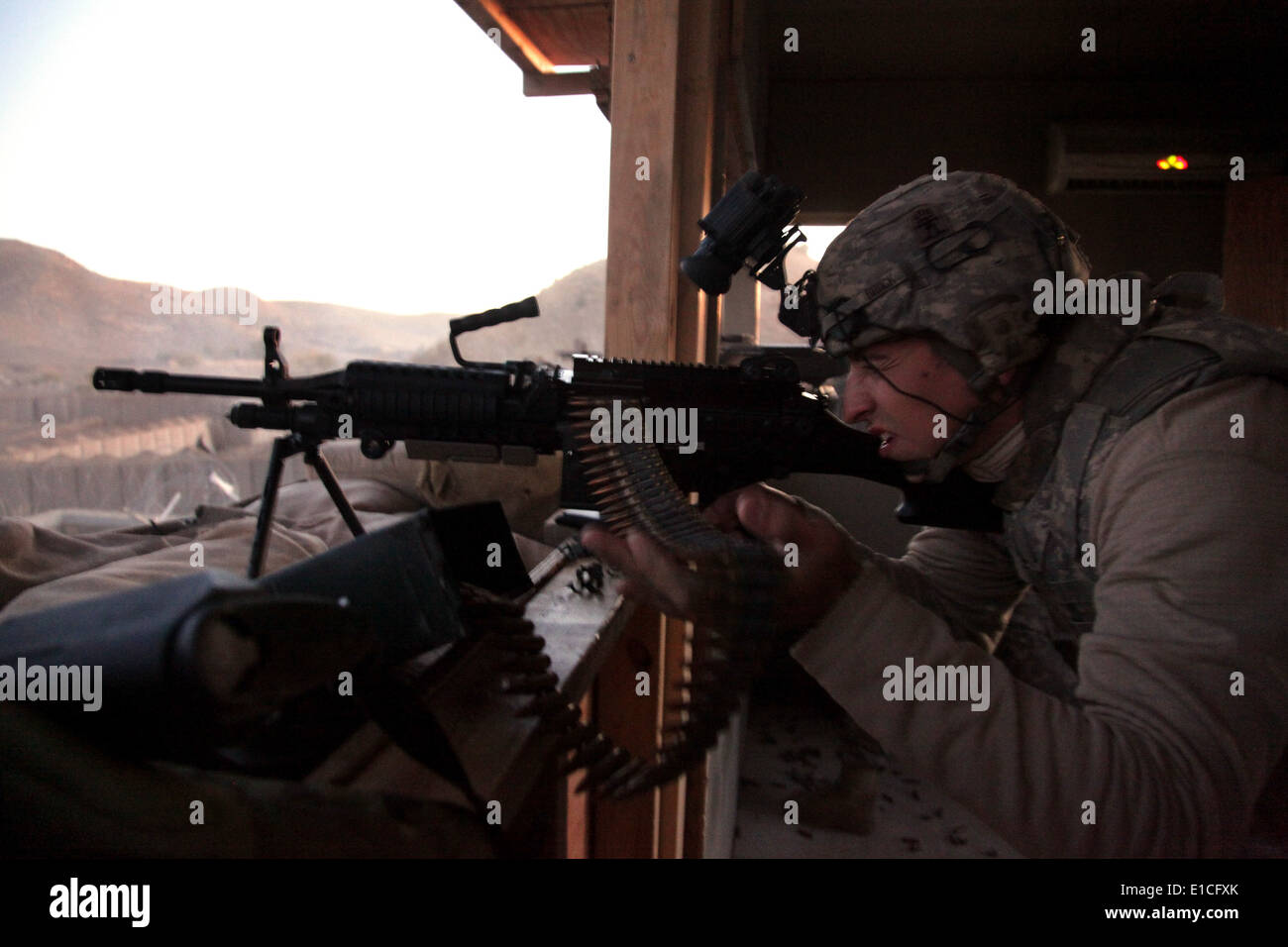 A U.S. Soldier fires an M-248 machine gun after receiving enemy mortar ...