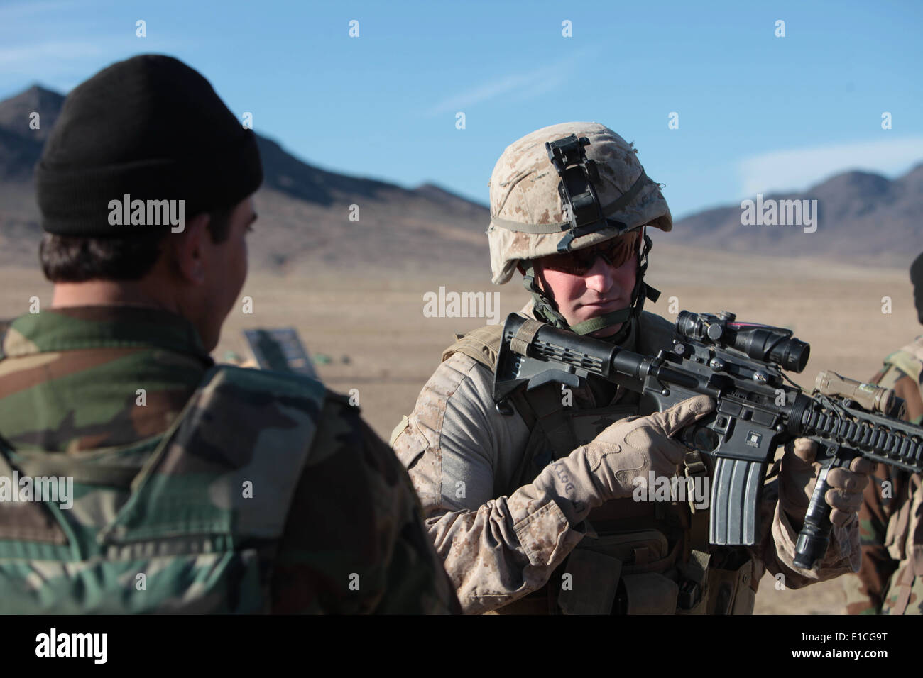 U.S. Marine Corps 1st Lt. Christopher Doty coaches an Afghan National ...