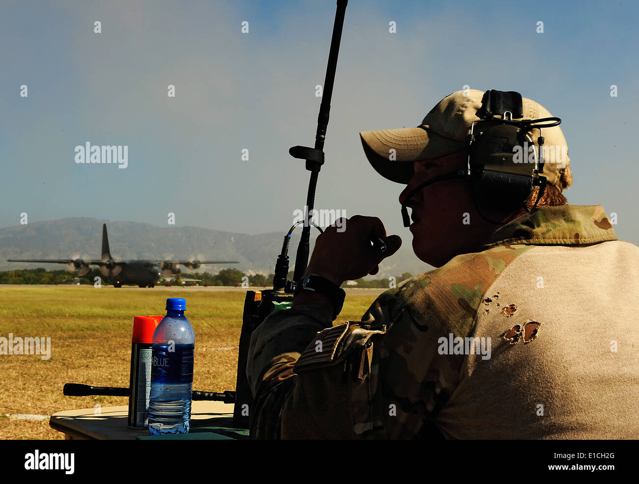 A U.S. Air Force combat controller conducts air traffic control ...