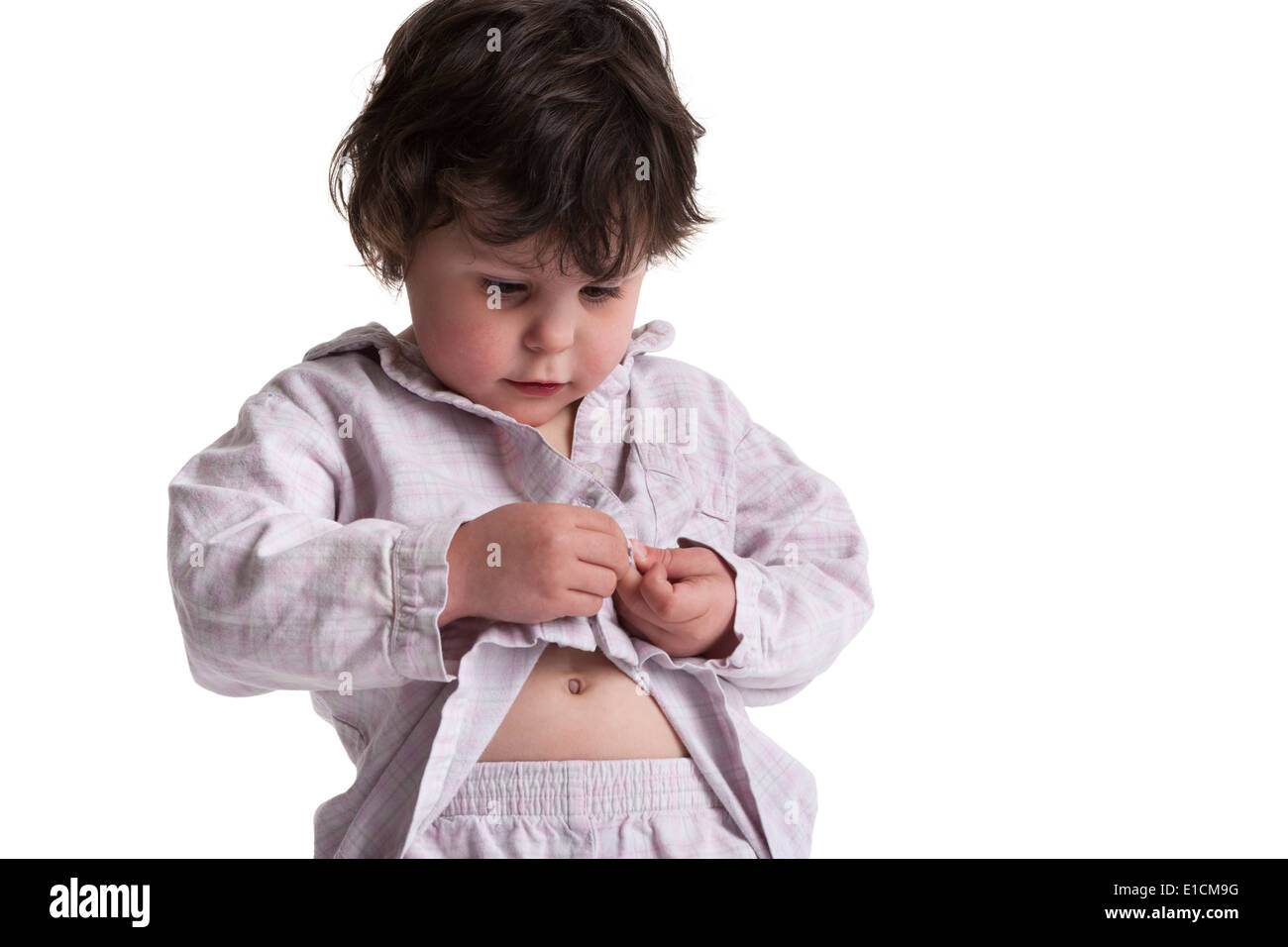Three year old girl fastening buttons on white background Stock Photo ...
