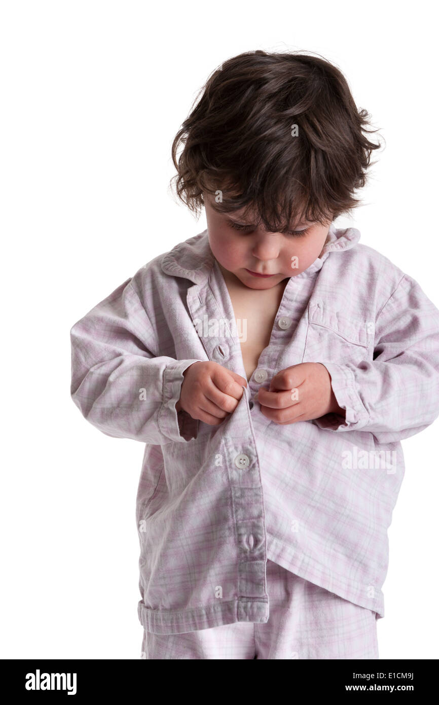 Three year old girl fastening buttons on white background Stock Photo ...