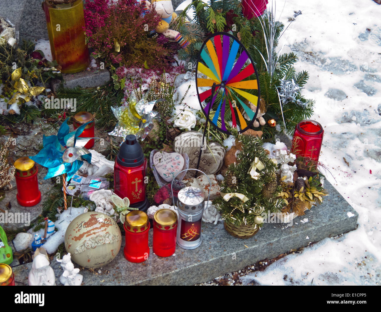 Toy items and candles on the grave of a child Stock Photo - Alamy