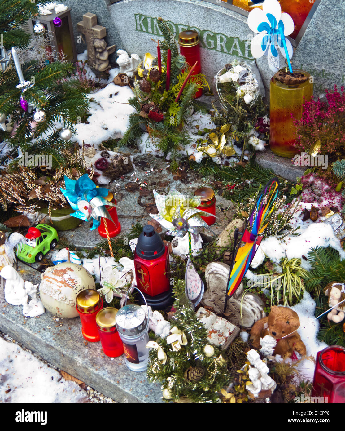 Toy items and candles on the grave of a child Stock Photo - Alamy