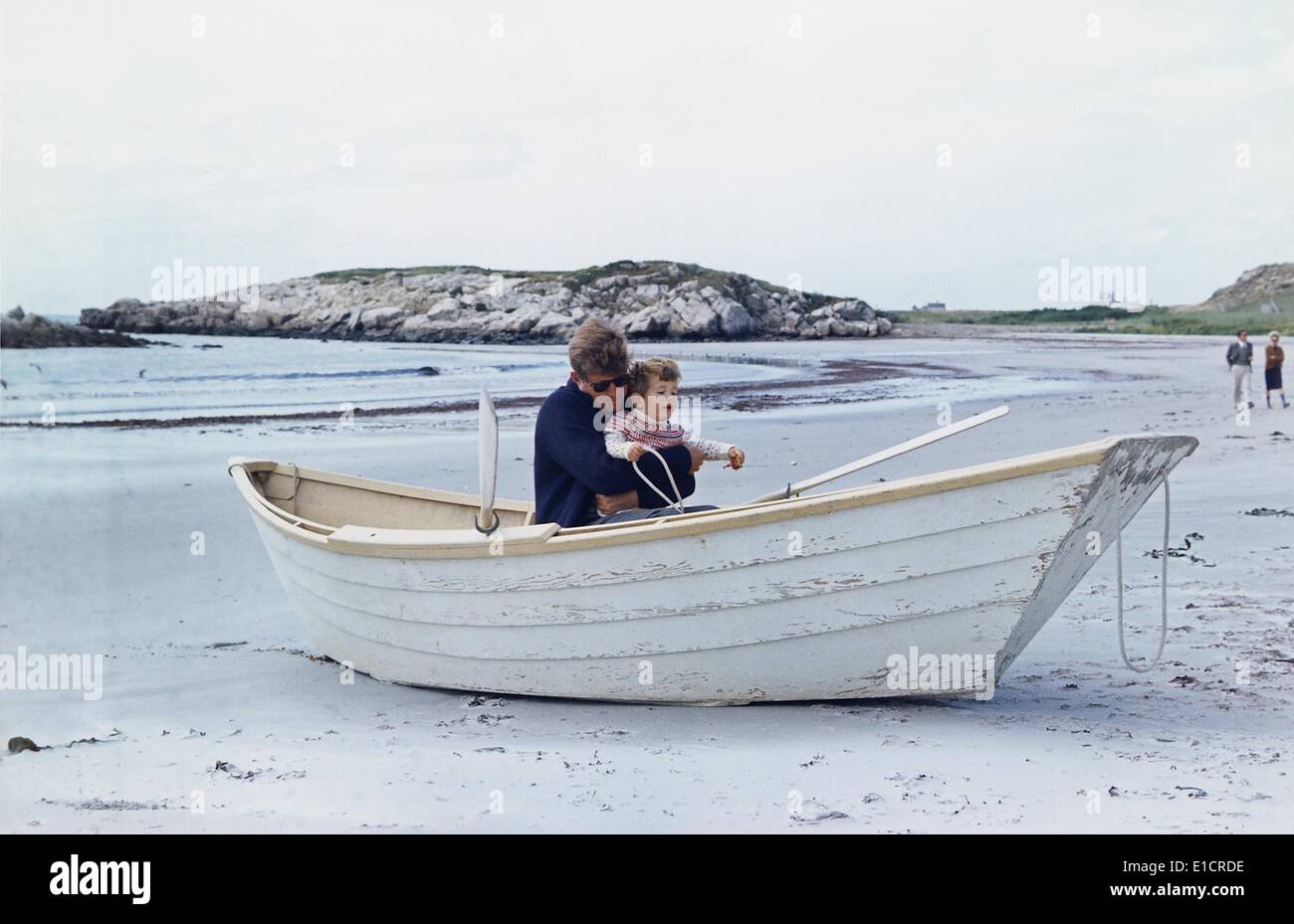 President John Kennedy and John Jr. play in a beached rowboat at ...