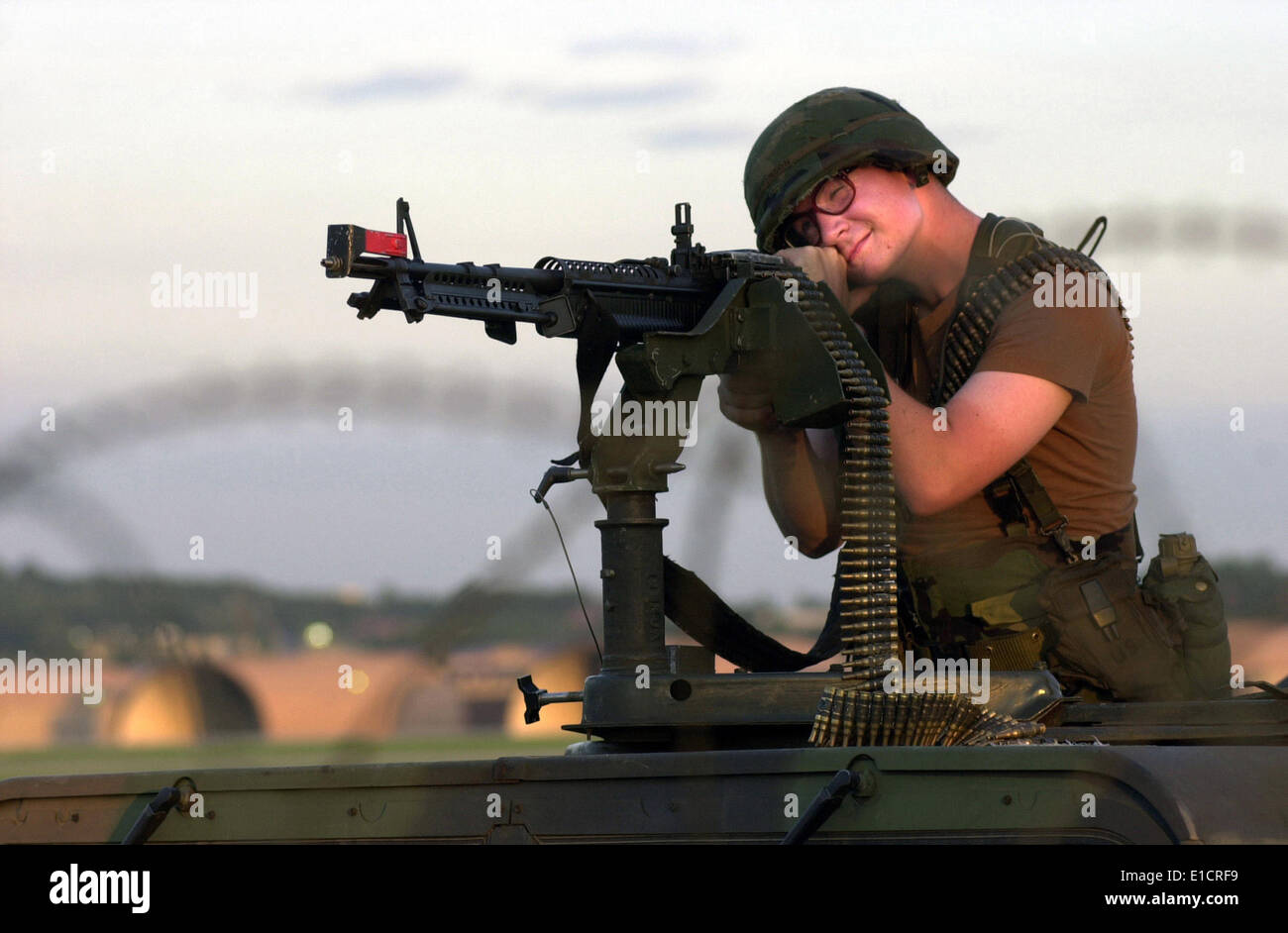 An airman mans a M-60 machine gun at a defensive firing position during ...