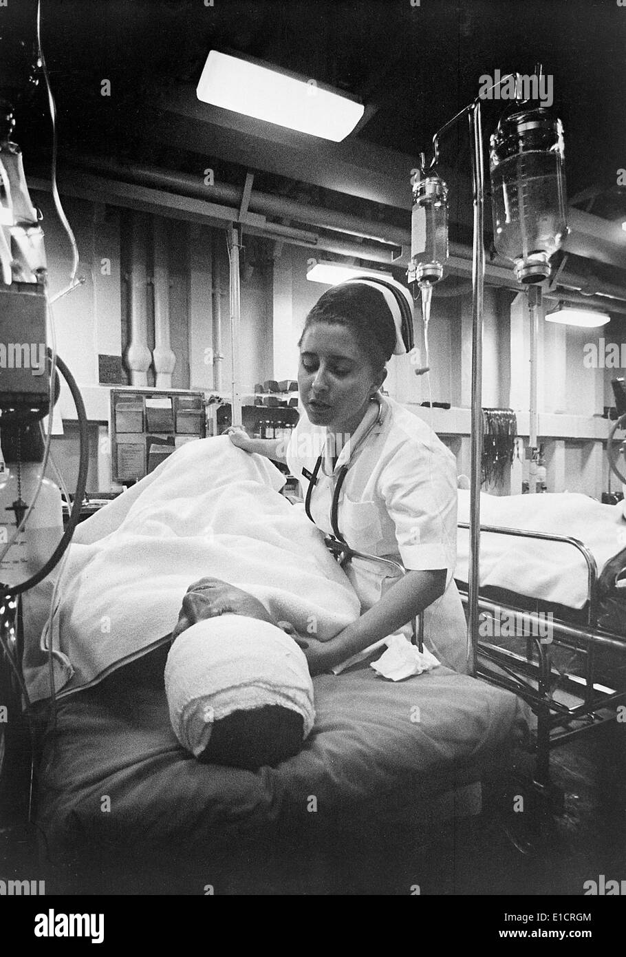 Vietnam War. A nurse tends to a patient just out of surgery in the ...