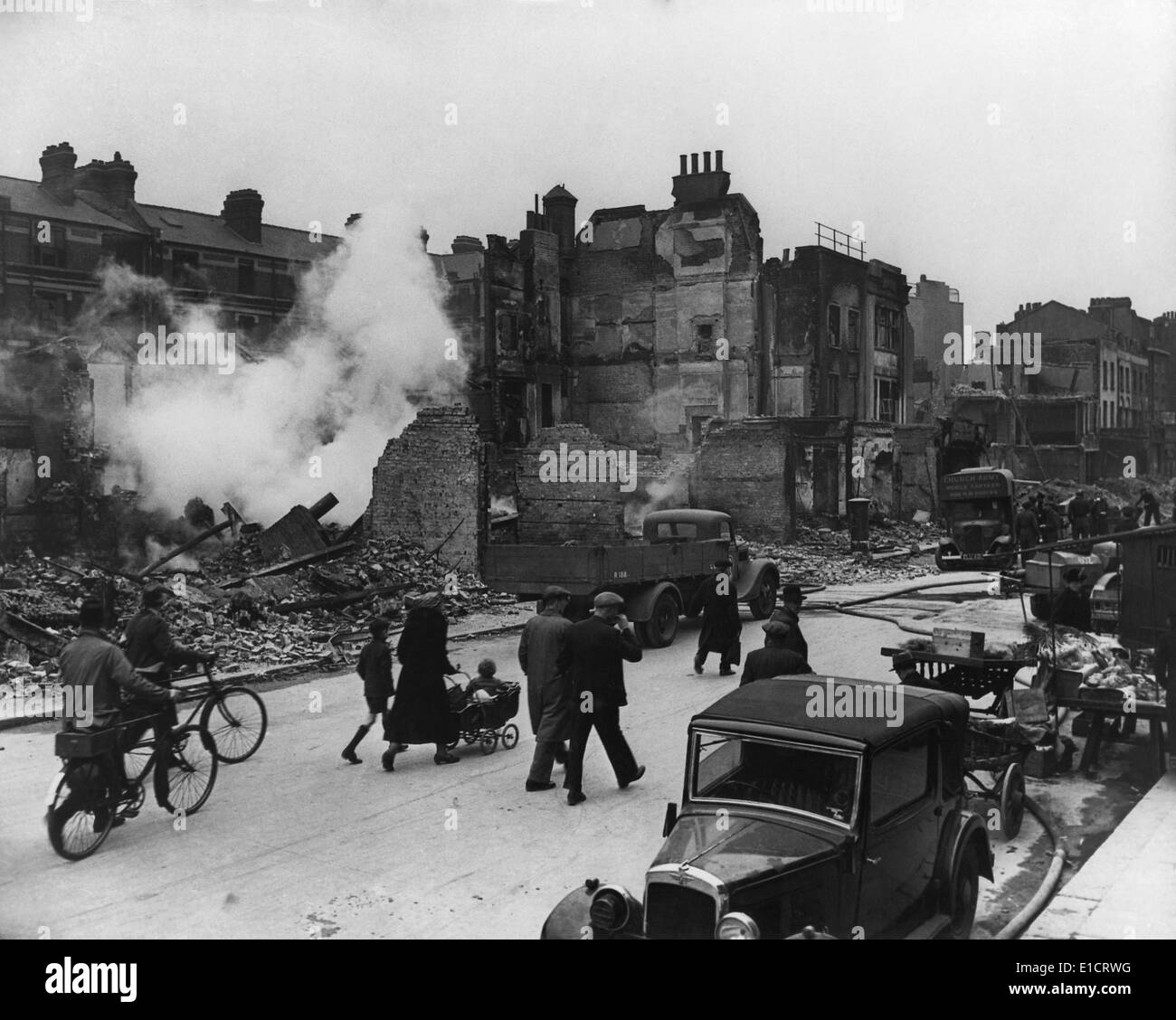 World War 2, Battle of Britain. Londoners walk through a ruined street ...
