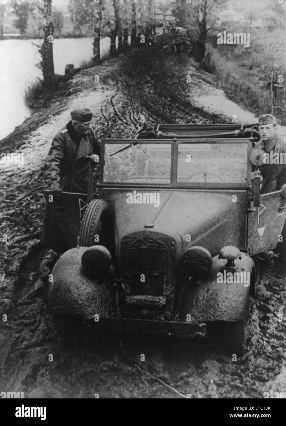 German soldier and officer pushing their car through Russian mud. In ...