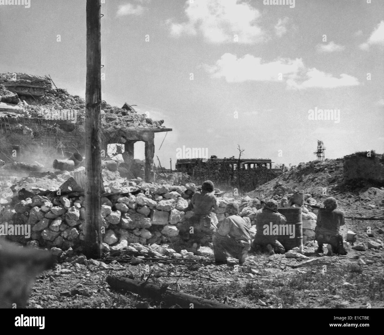 Marines of the First Division fire on Japanese snipers in a building on ...