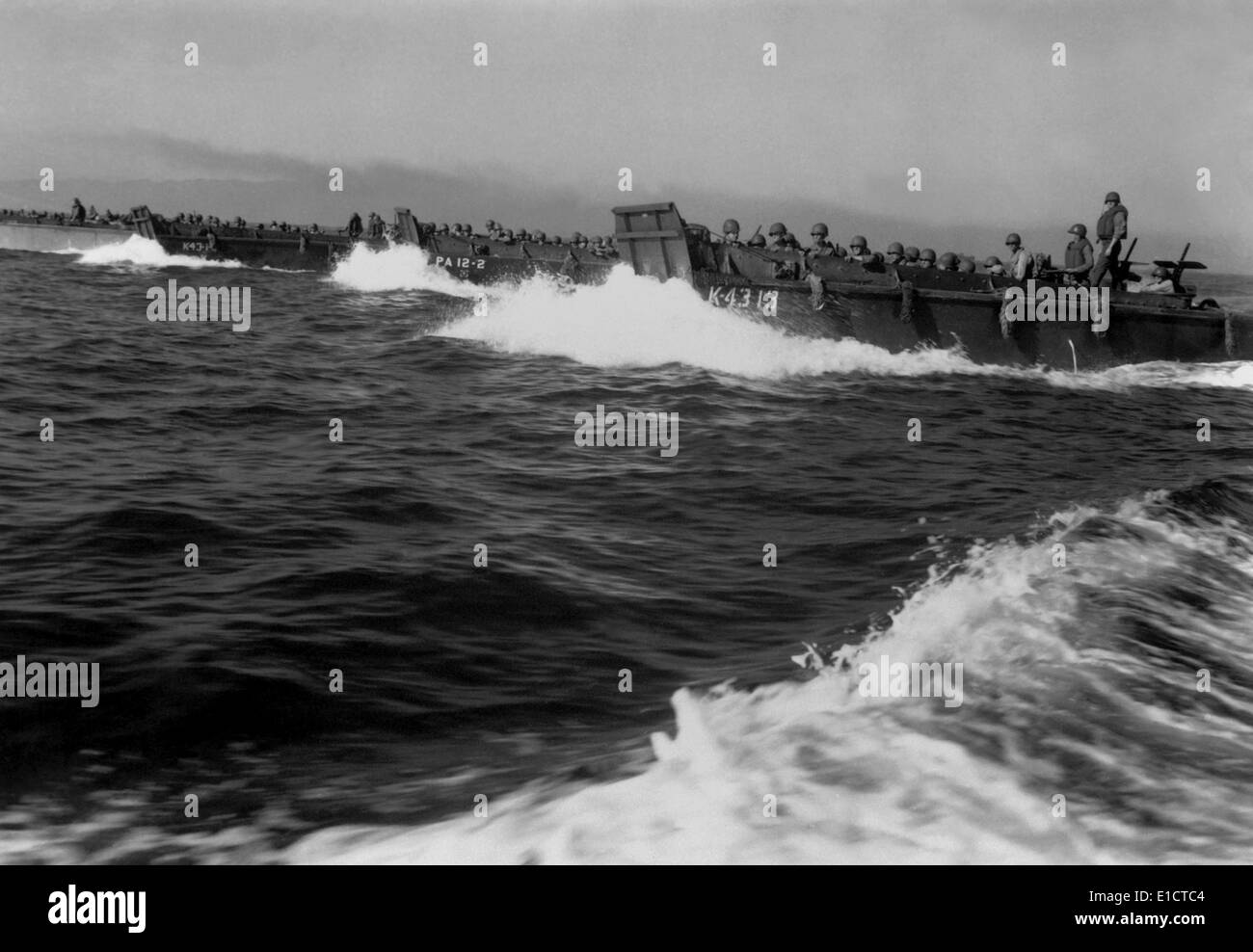 Landing barges, in Lingayen Gulf, carry the first wave of U.S. invaders ...