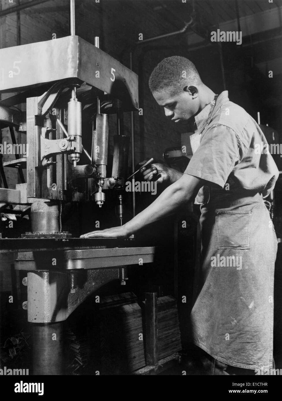 African American machine operator working during World War 2. In June ...