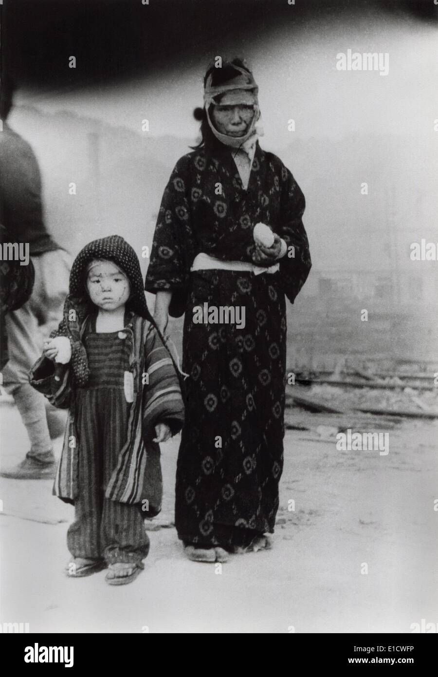 Nagasaki atomic bomb survivors holding boiled rice balls distributed by ...