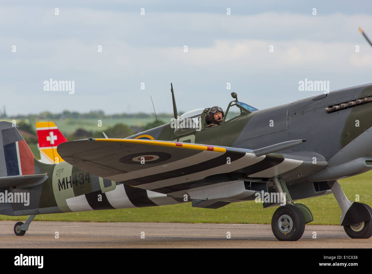 A World War II Spitfire fighter at Duxford Air Show in D-Day markings ...