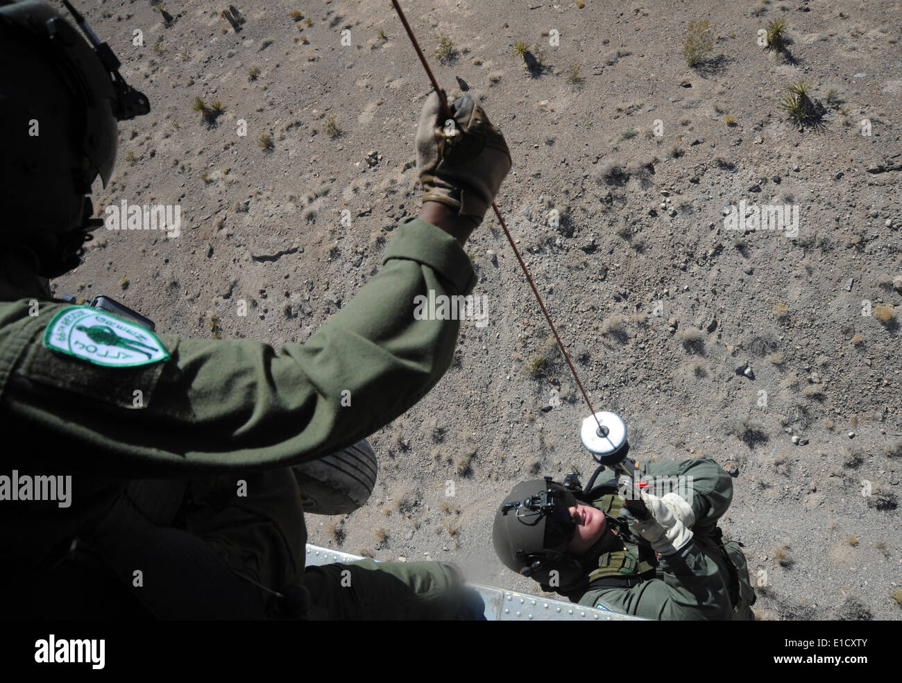 U.S. Air Force Tech. Sgt. Mark Moore, left, operates a hoist while ...
