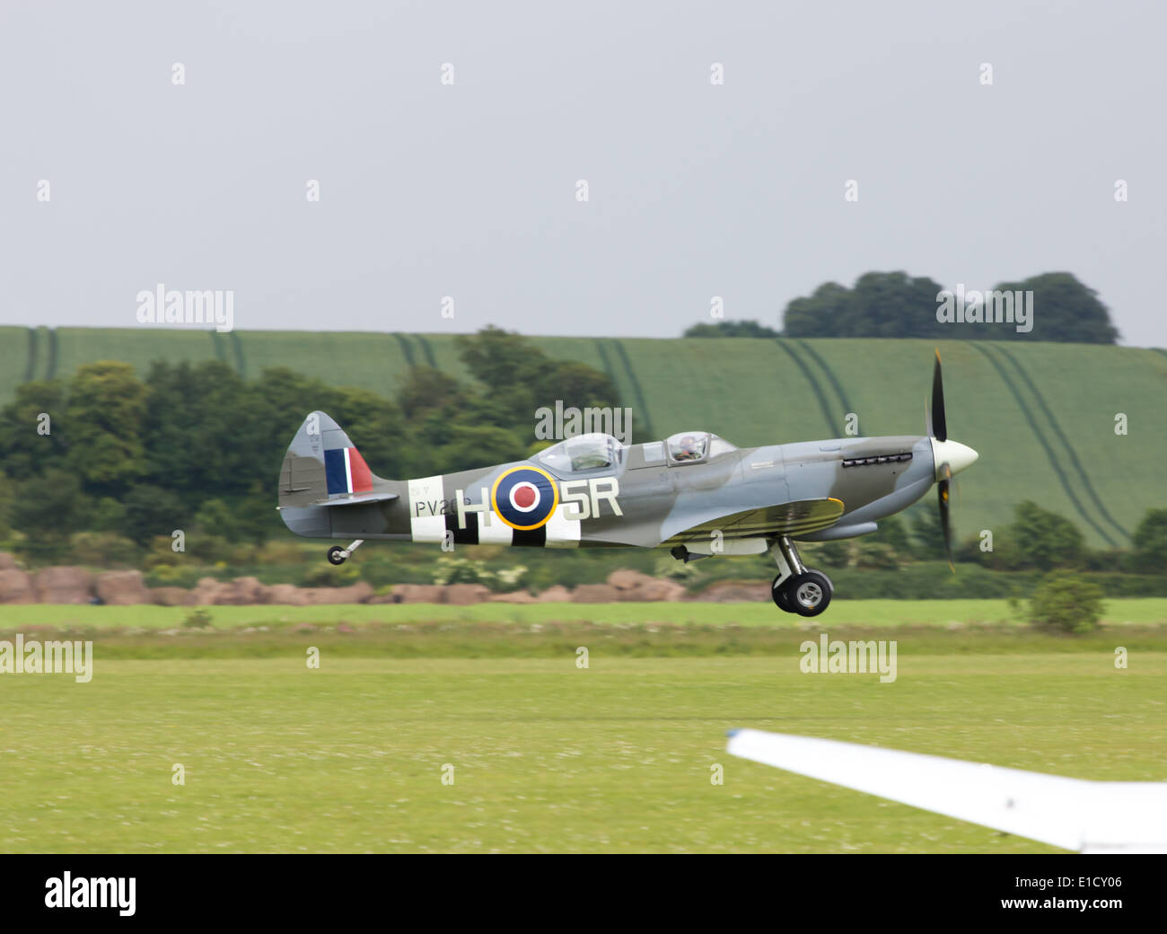 A World War II Spitfire fighter at Duxford Air Show in D-Day markings to celebrate the 70th ...