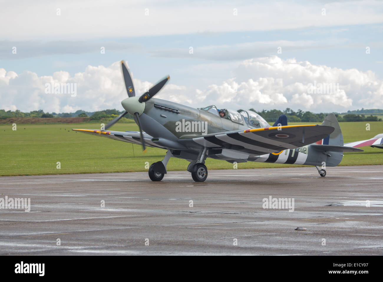 A World War II Spitfire fighter at Duxford Air Show in D-Day markings ...