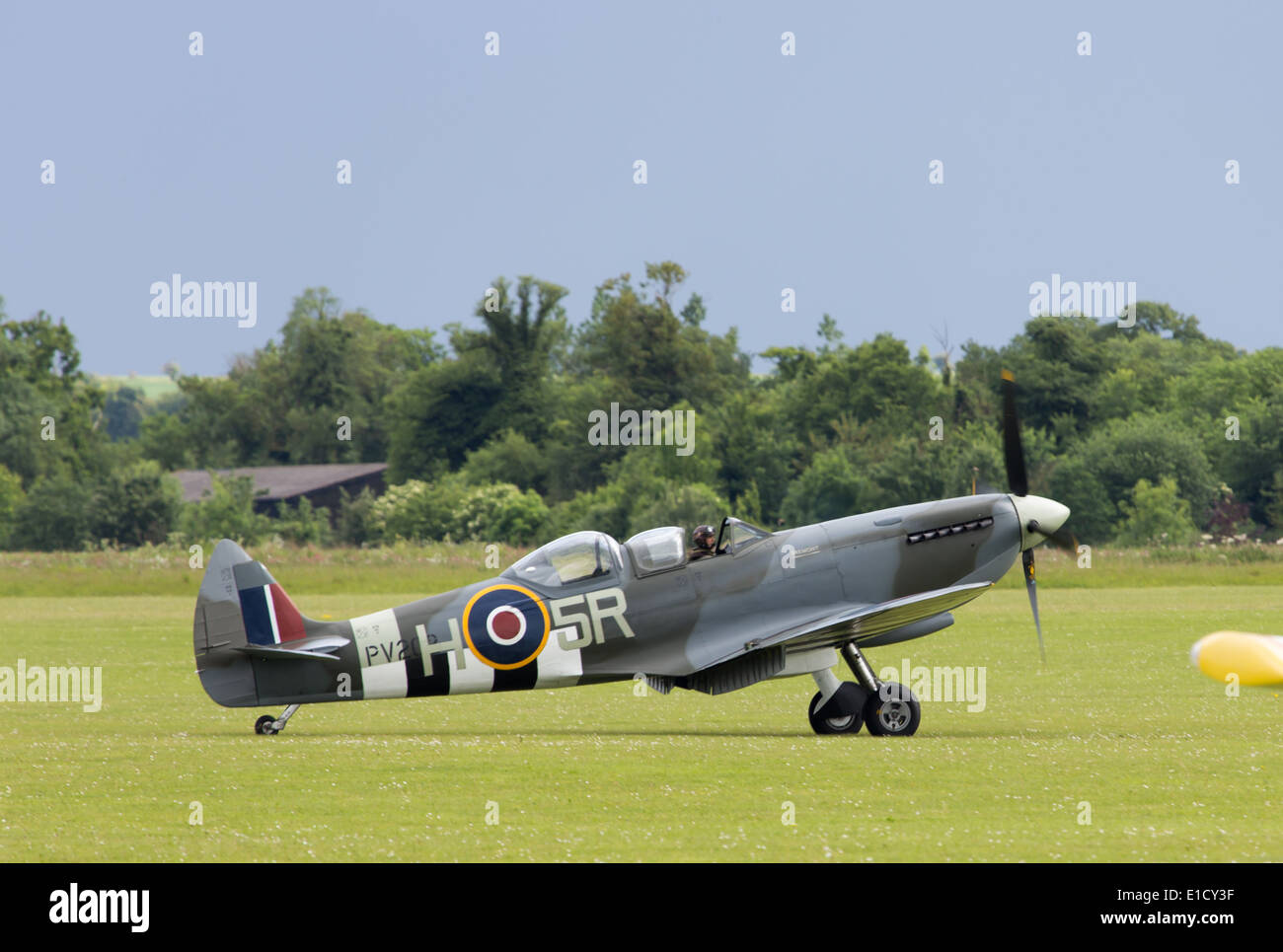A World War II Spitfire fighter at Duxford Air Show in D-Day markings ...