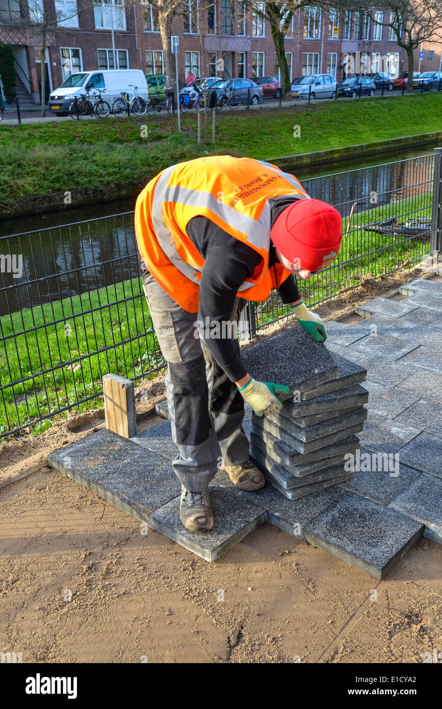 paviours at work in street in town Stock Photo - Alamy