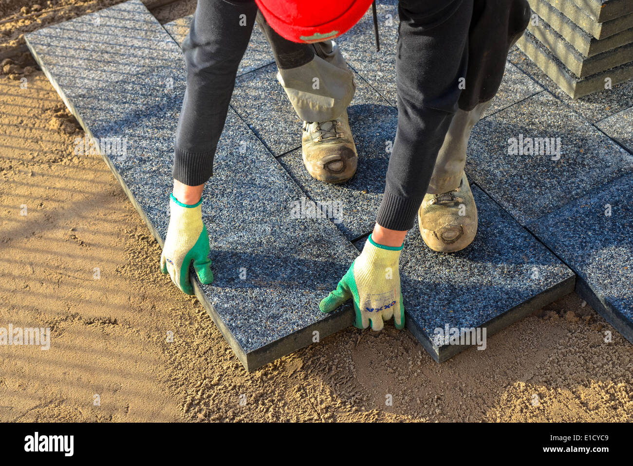 paviours at work in street in town Stock Photo - Alamy