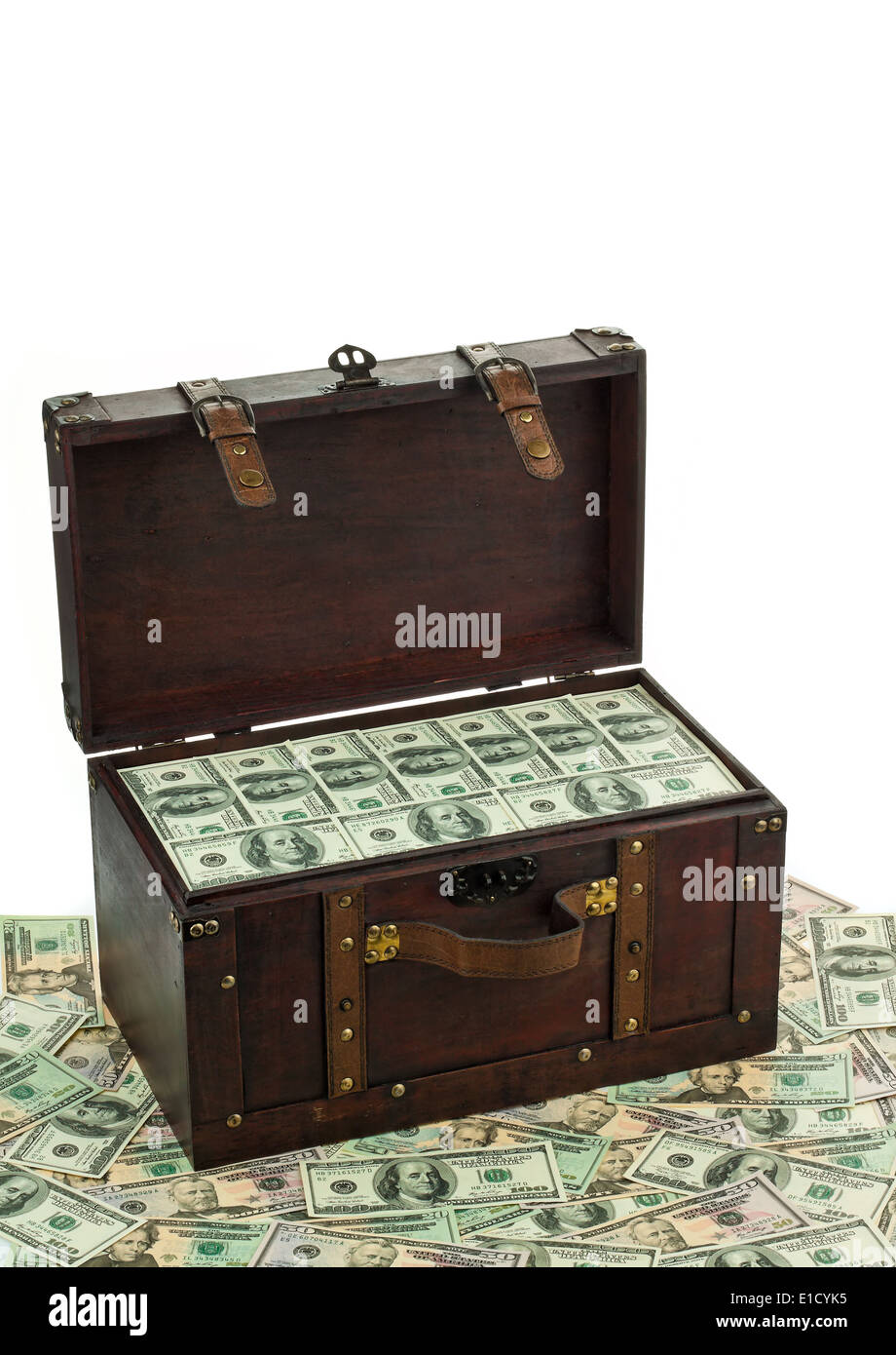A treasure chest with lots of dollar bills. Isolated against a white ...