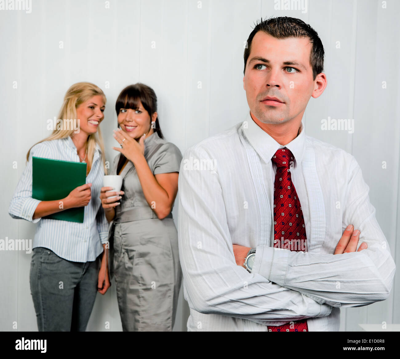 Bullying at the workplace in the office. Women make fun of man Stock ...