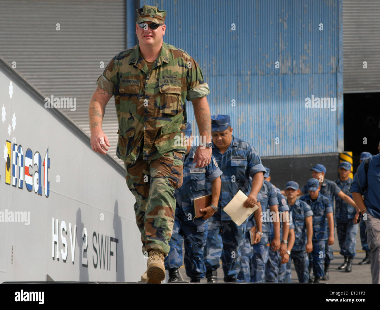 U.S. Navy Senior Chief Gunner's Mate Edward Middendorf leads members of ...