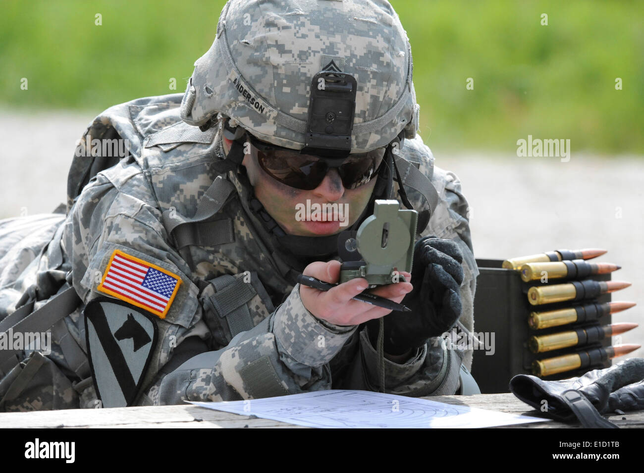 U.S. Army Staff Sgt. Alicia Anderson uses a compass to draw a range map ...