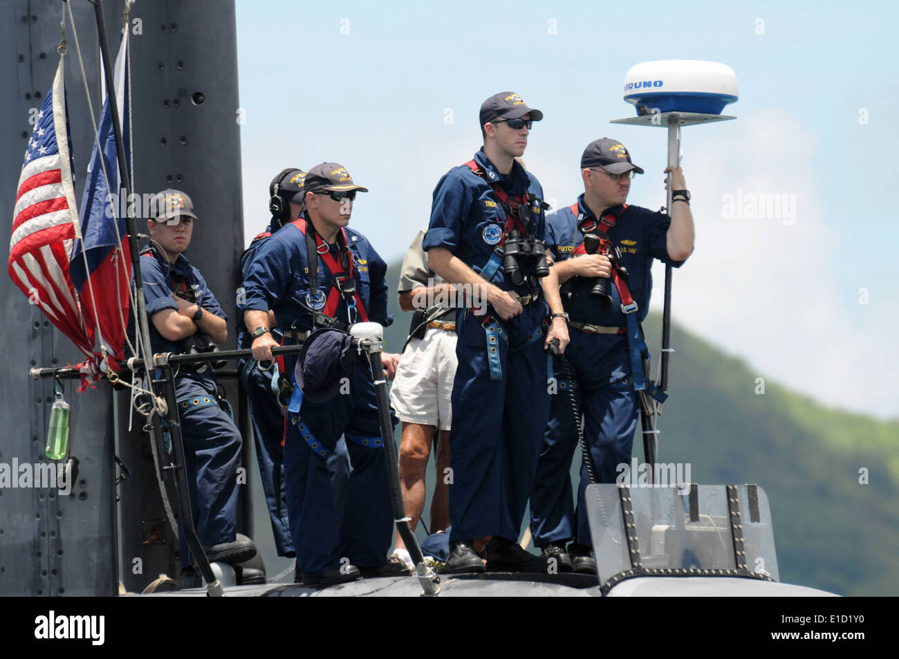 U.S. Sailors aboard the attack submarine USS Houston (SSN 713) watch ...