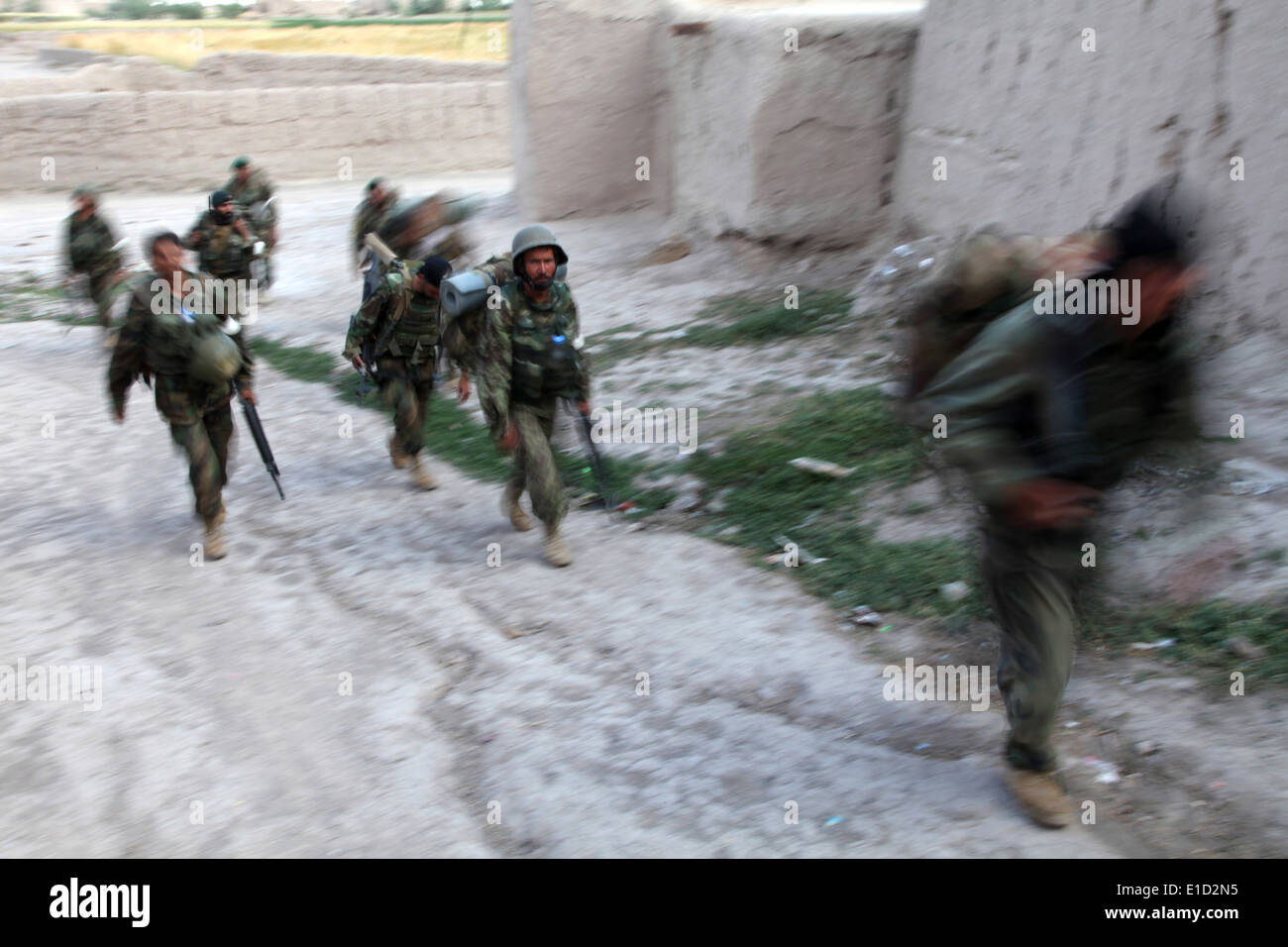 Afghan National Army soldiers move through a qalat during an operation ...