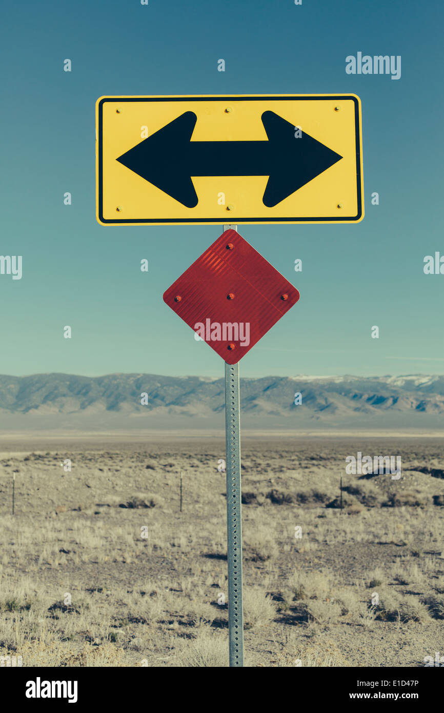 Directional arrow sign along rural road near Orvada Stock Photo - Alamy