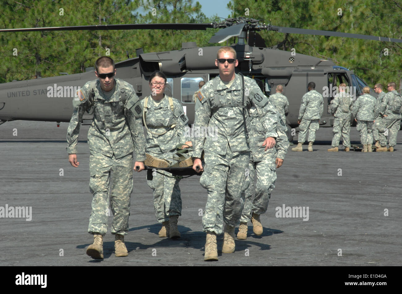 U.S. Army medical personnel practice loading medical litters onto an HH ...