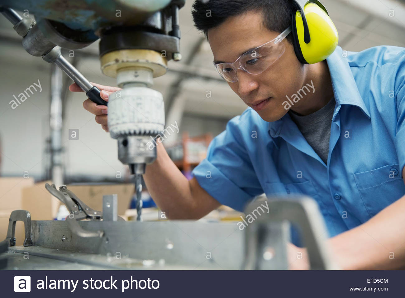 Worker operating machinery in manufacturing hi-res stock photography ...