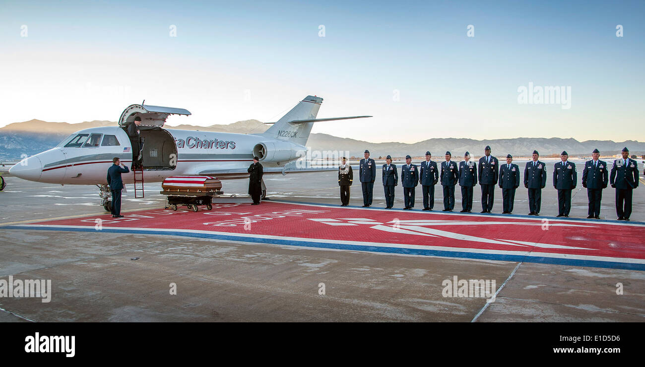 U.S. Airmen stand at attention as a casket containing the remains of ...