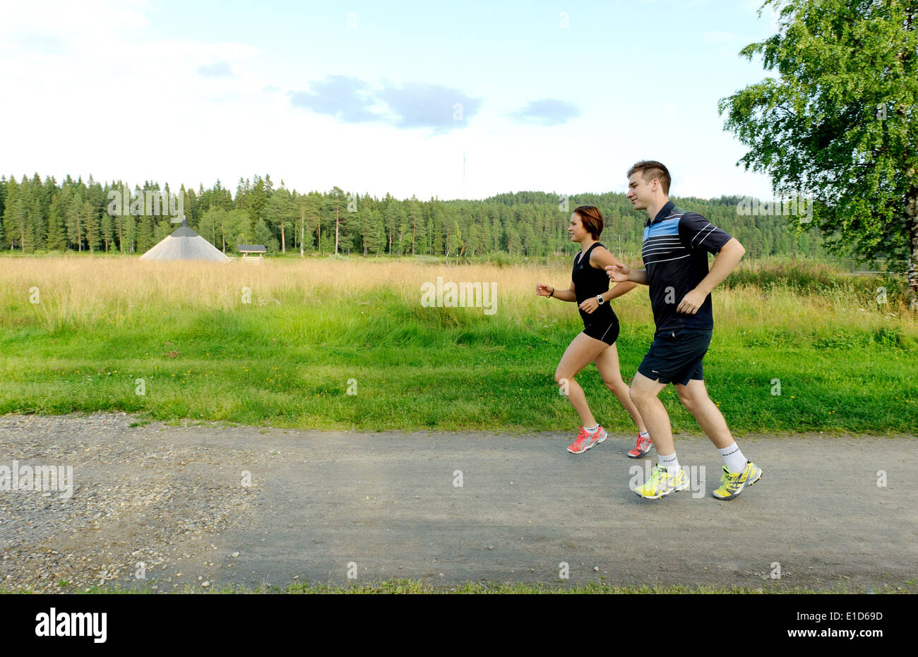 Young couple running outside Stock Photo - Alamy