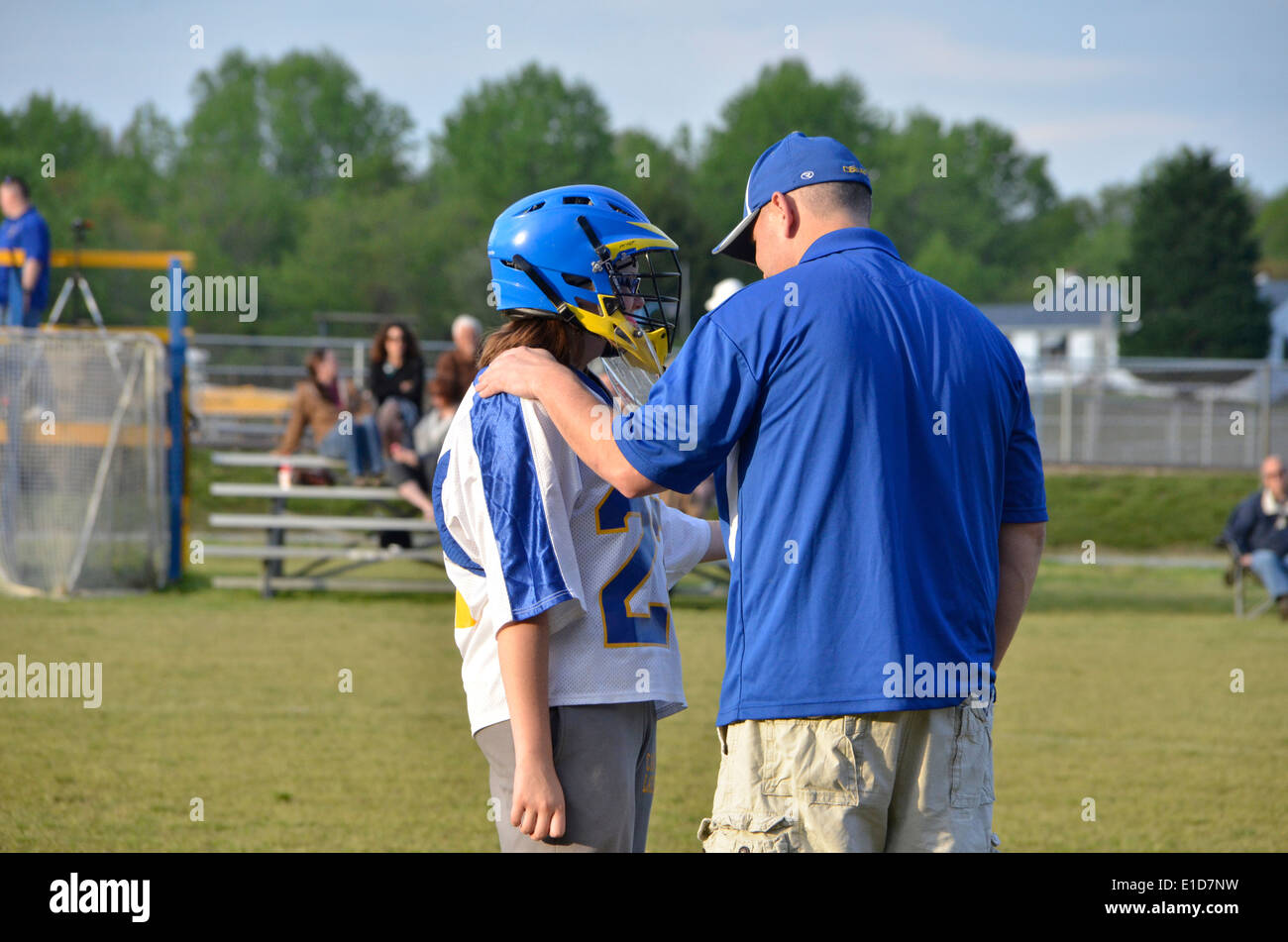 Coach helping girl's lacrosse player to play better Stock Photo - Alamy