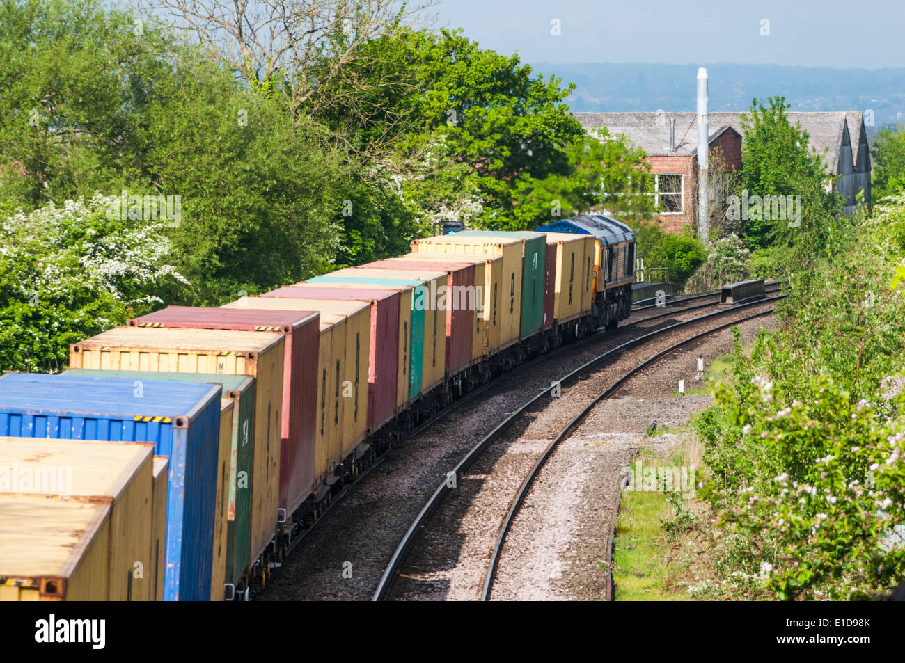 A GBRF class 66 diesel loco heads a westbound freight train laden with ...