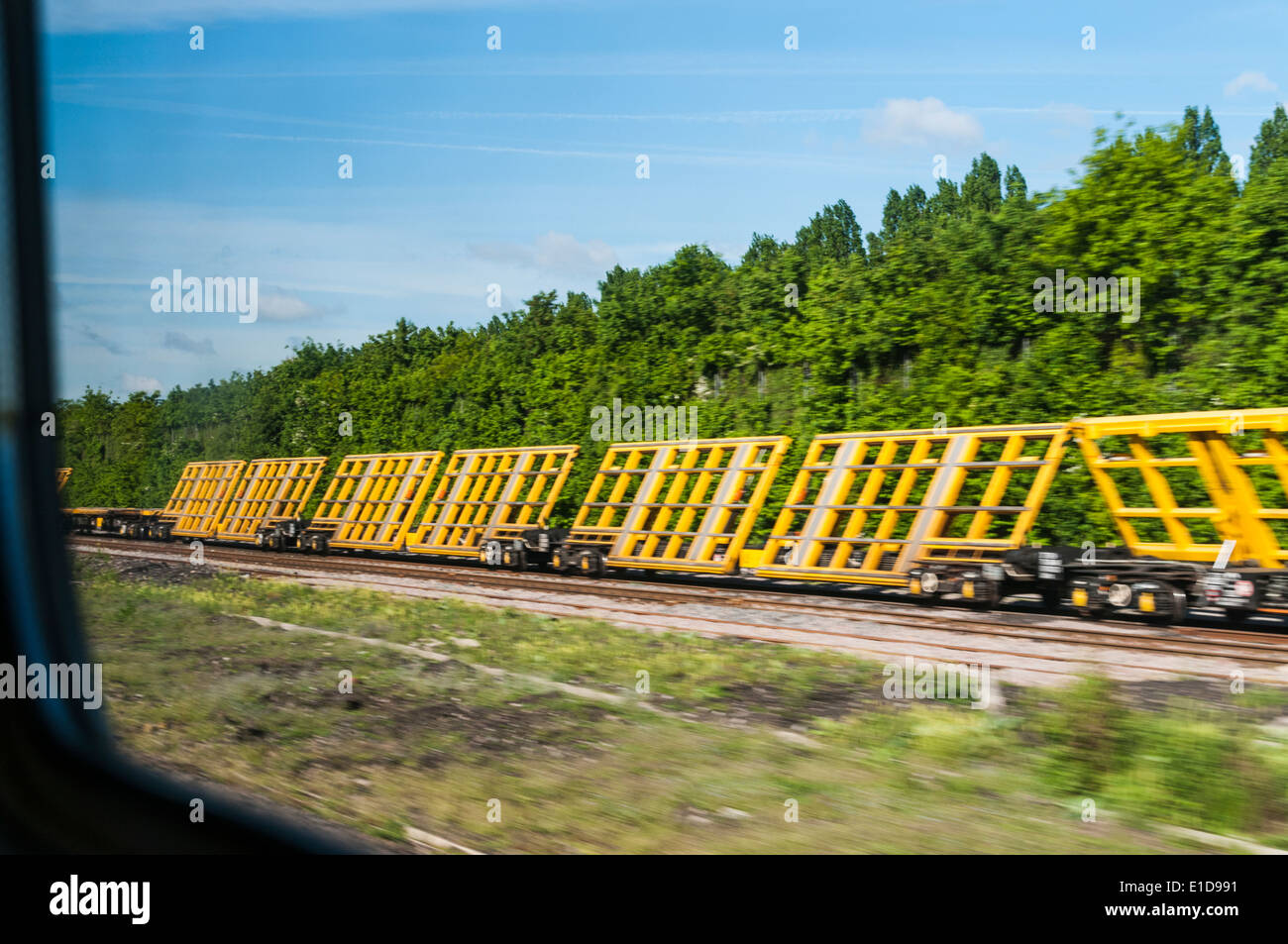 Looking out of a train window as an engineering train passes made up of ...