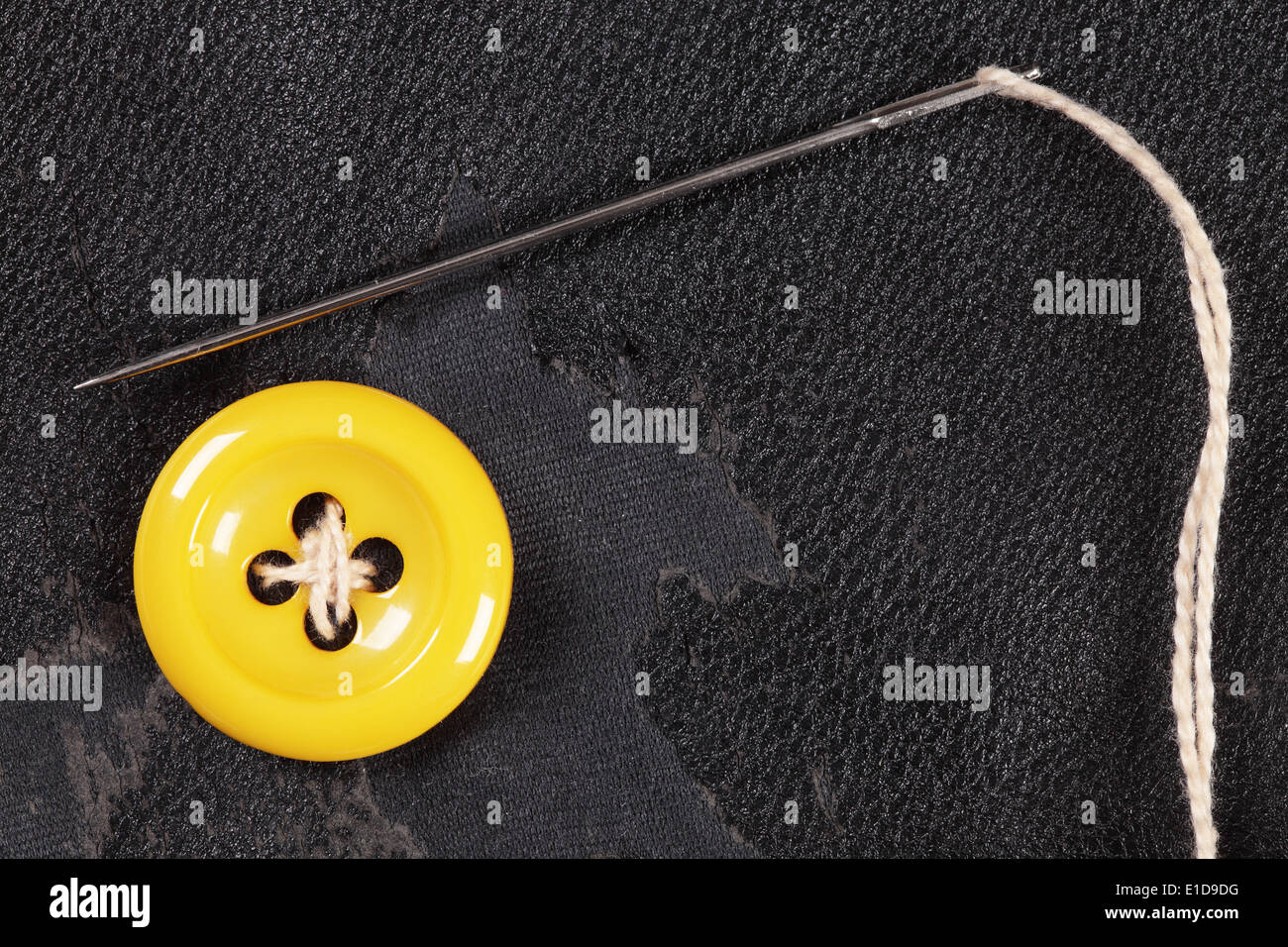 yellow button on a leather fabric Stock Photo - Alamy