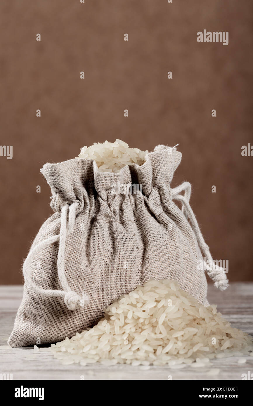 burlap sack full of rice Stock Photo - Alamy