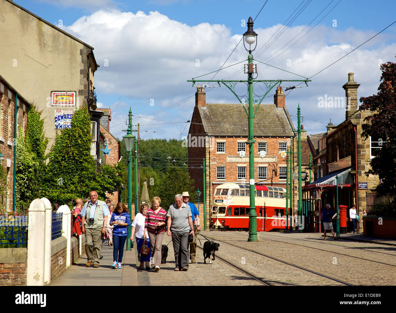 Tourists, tramlines and an old tram in the high street of the Edwardian ...