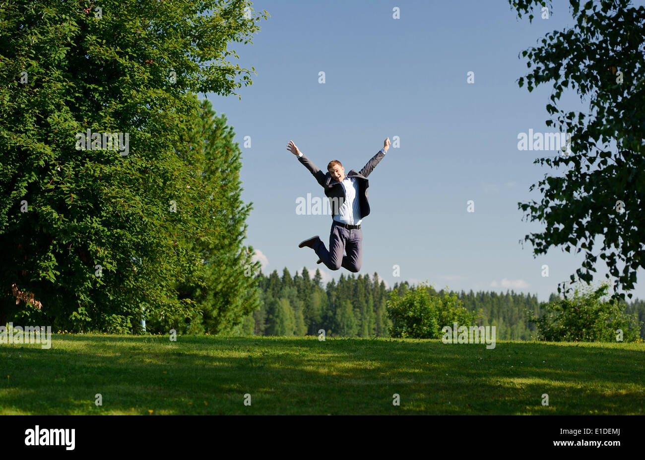 Young man jumping outside Stock Photo - Alamy