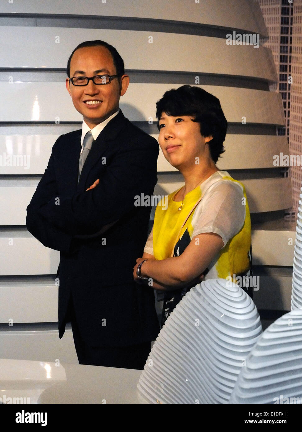 Beijing, China. 1st June, 2014. A visitor poses for photos with a wax figure of China's real ...