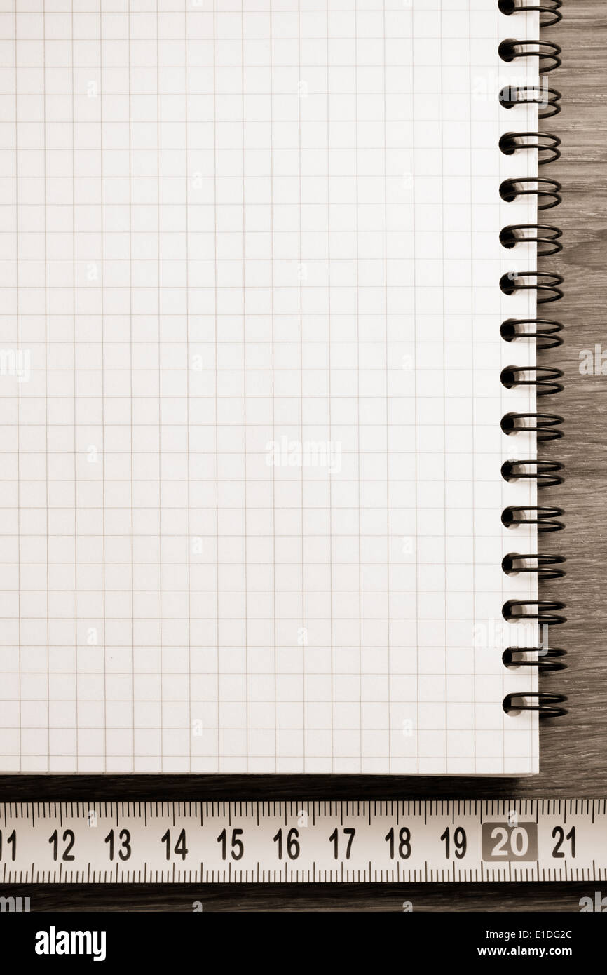 checked notebook on wooden background Stock Photo - Alamy
