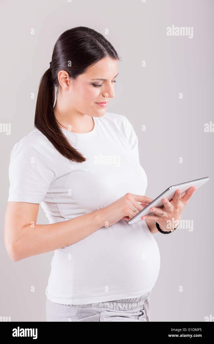 Young pregnant woman with tablet Stock Photo - Alamy